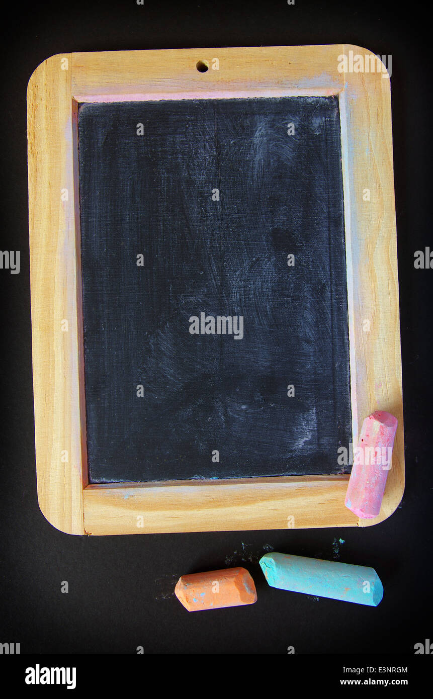 Dirty and used old slate and pieces of colored chalk Stock Photo - Alamy
