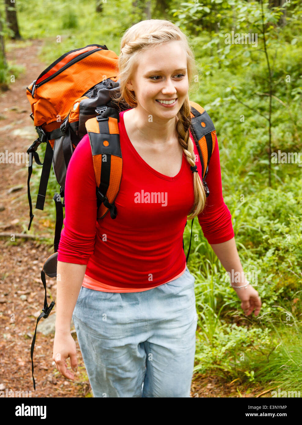 Young beautiful woman hiking in a forest Stock Photo - Alamy