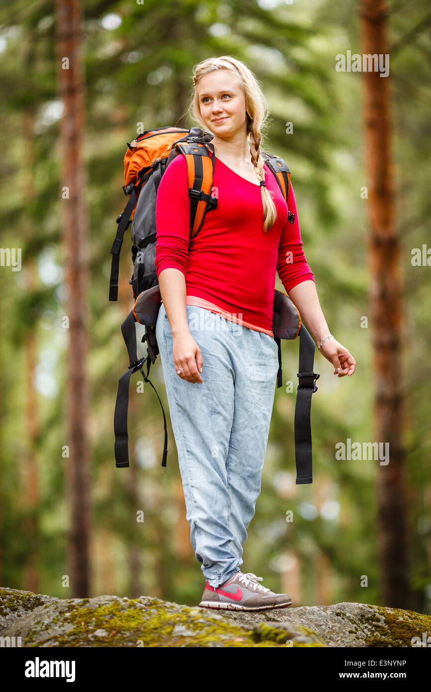 Young beautiful woman hiking in a forest Stock Photo - Alamy