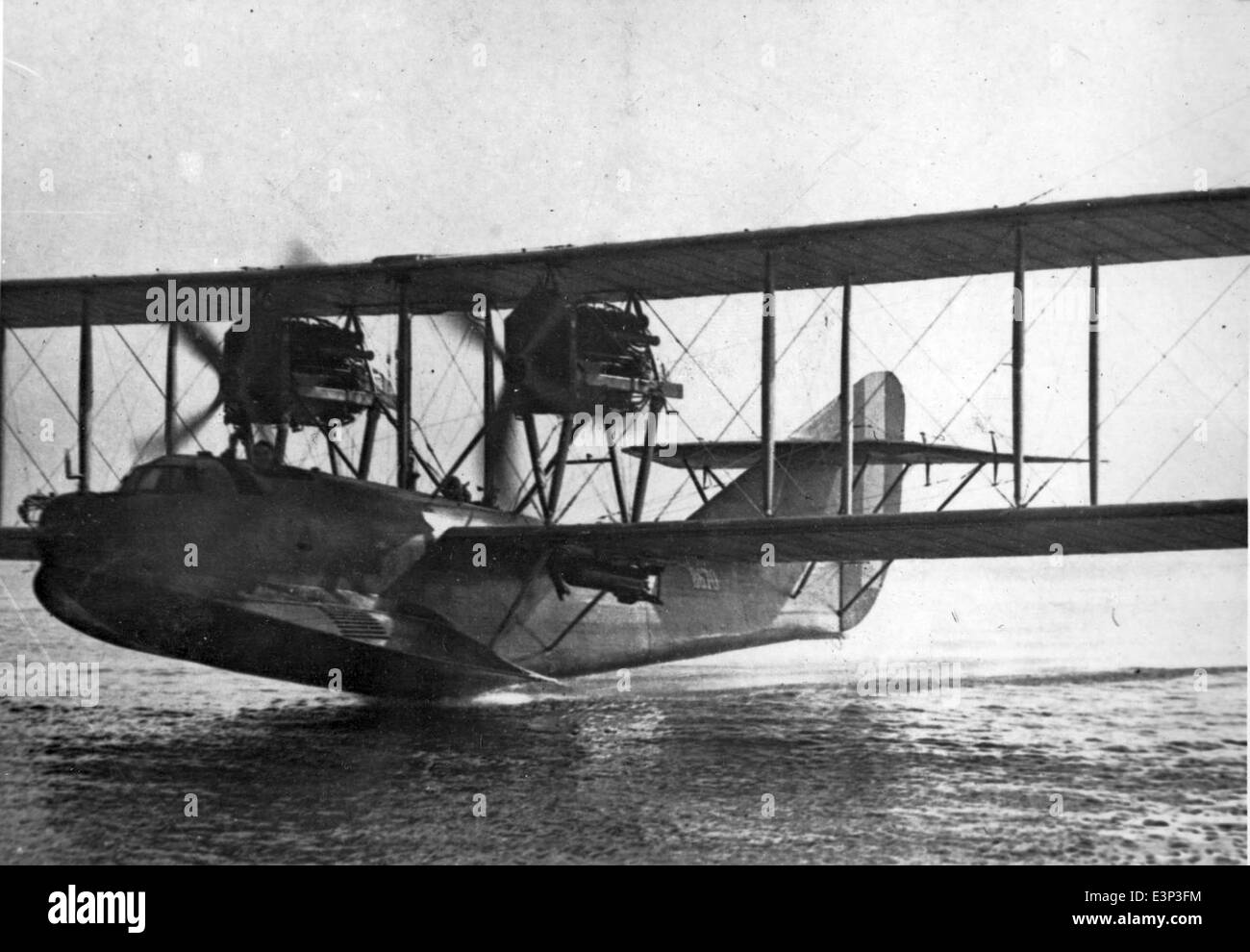 This photograph features the Curtiss H-16, a large flying boat ...