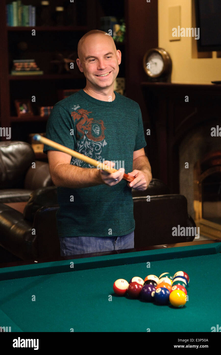 Handsome bald man playing pool Stock Photo - Alamy