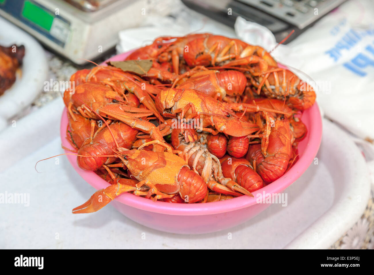 Plate with red boiled crawfish on a table close up Stock Photo - Alamy