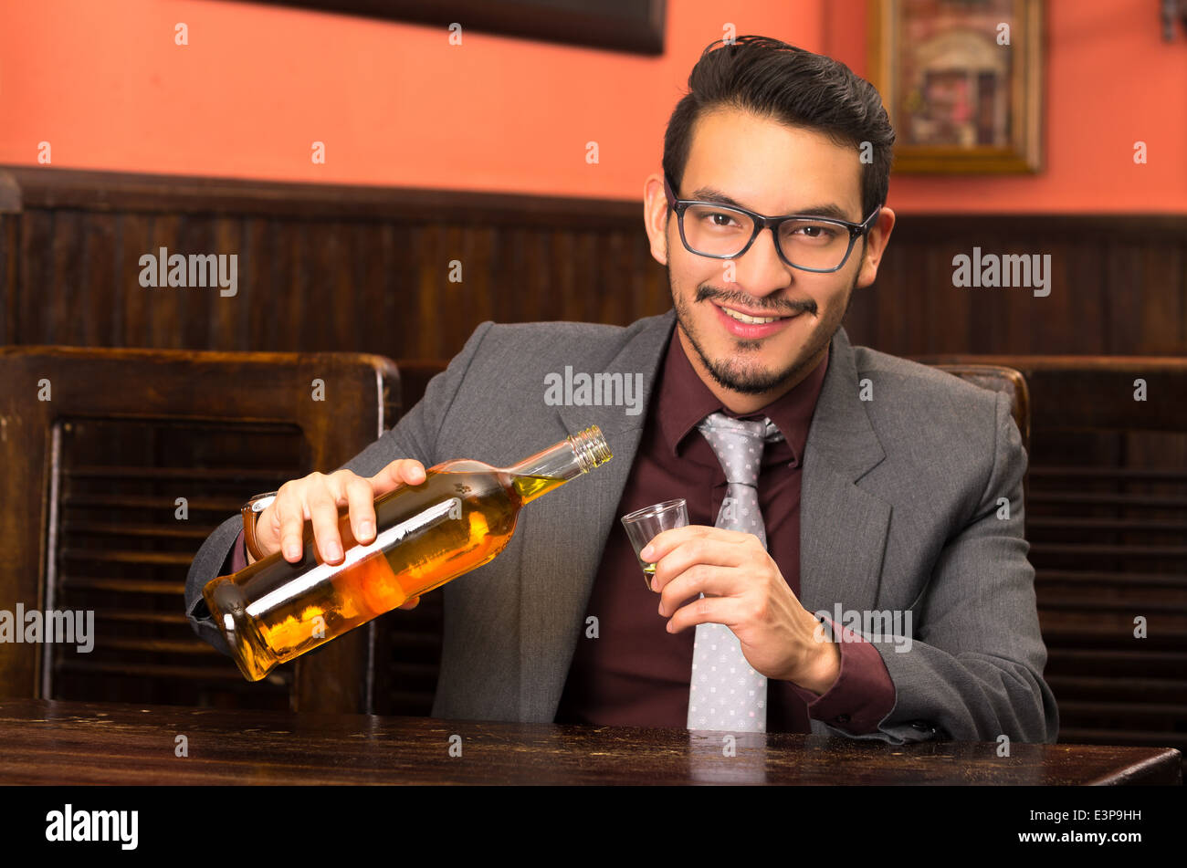 man in suit drinking alcohol shot Stock Photo - Alamy