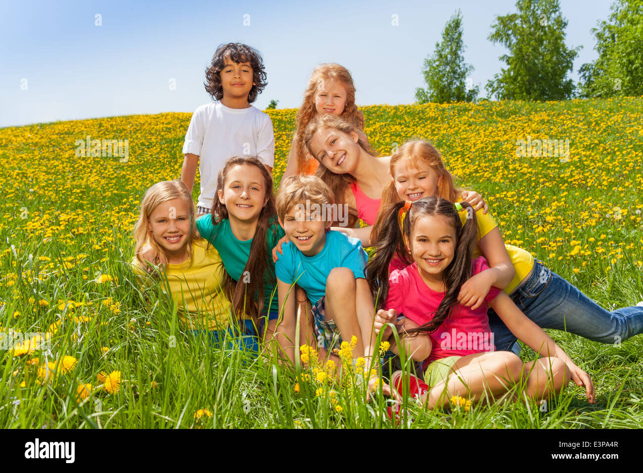 Group smiling kids sitting together hi-res stock photography and images ...