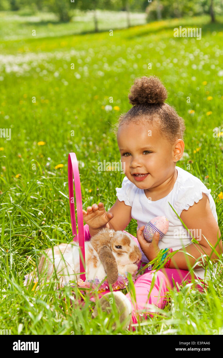 Happy beautiful girl with Eastern egg and rabbit Stock Photo - Alamy