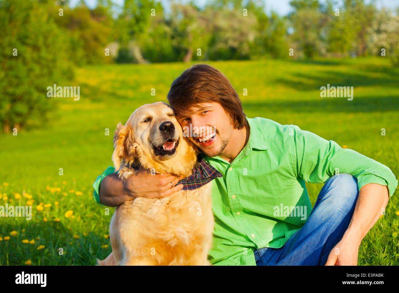 Happy dog and man in the park together Stock Photo - Alamy
