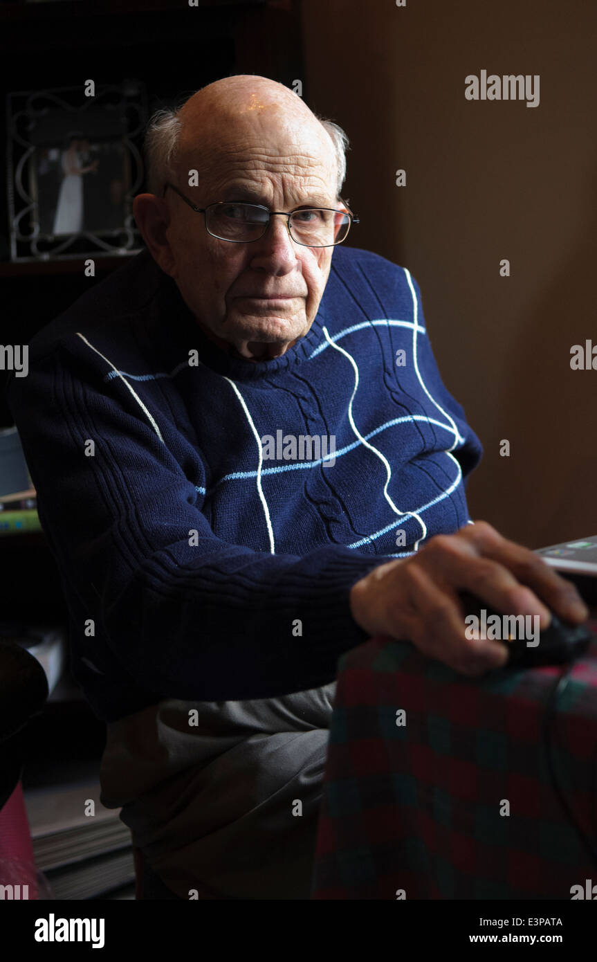 Elderly man working at computer, low key lighting. (MR Stock Photo - Alamy