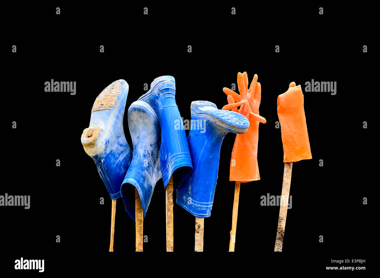 rubber boots hanging on black background Stock Photo - Alamy
