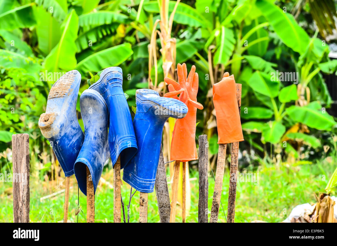 rubber boots hanging Stock Photo - Alamy