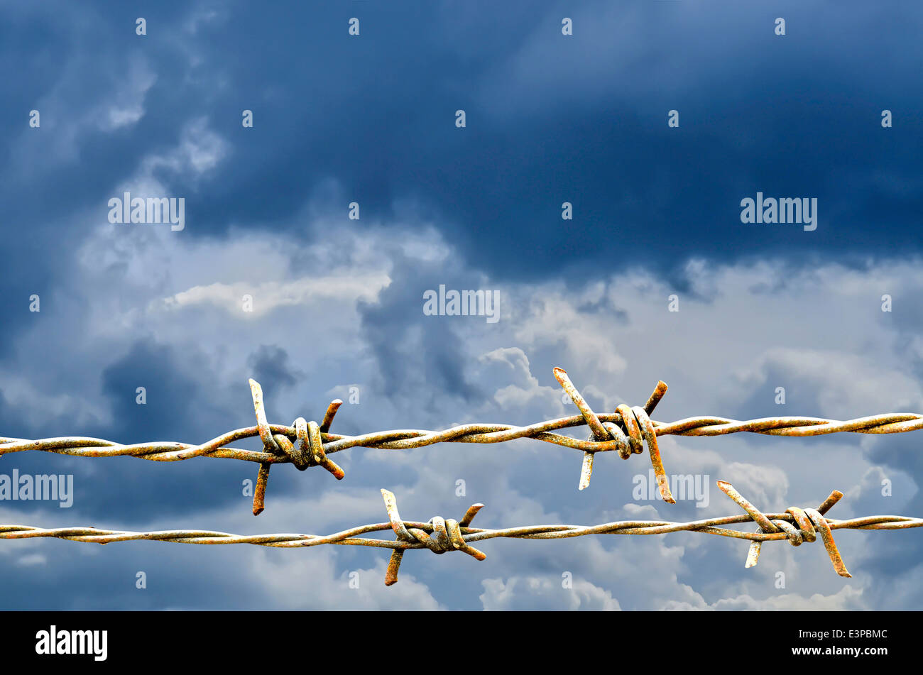 Strands of barb wire isolated on rain clound Stock Photo - Alamy