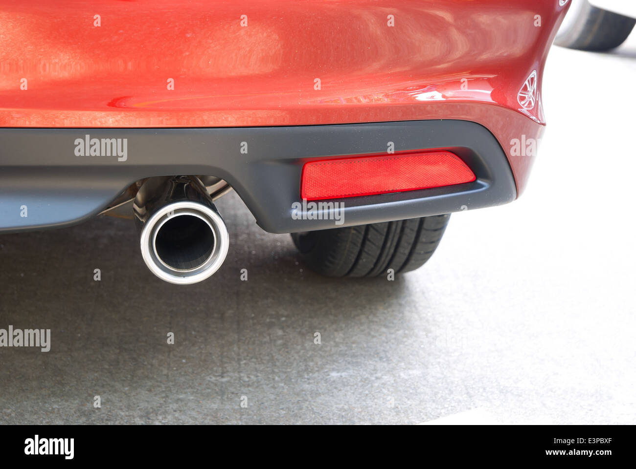 exhaust pipe of a red car close up Stock Photo - Alamy