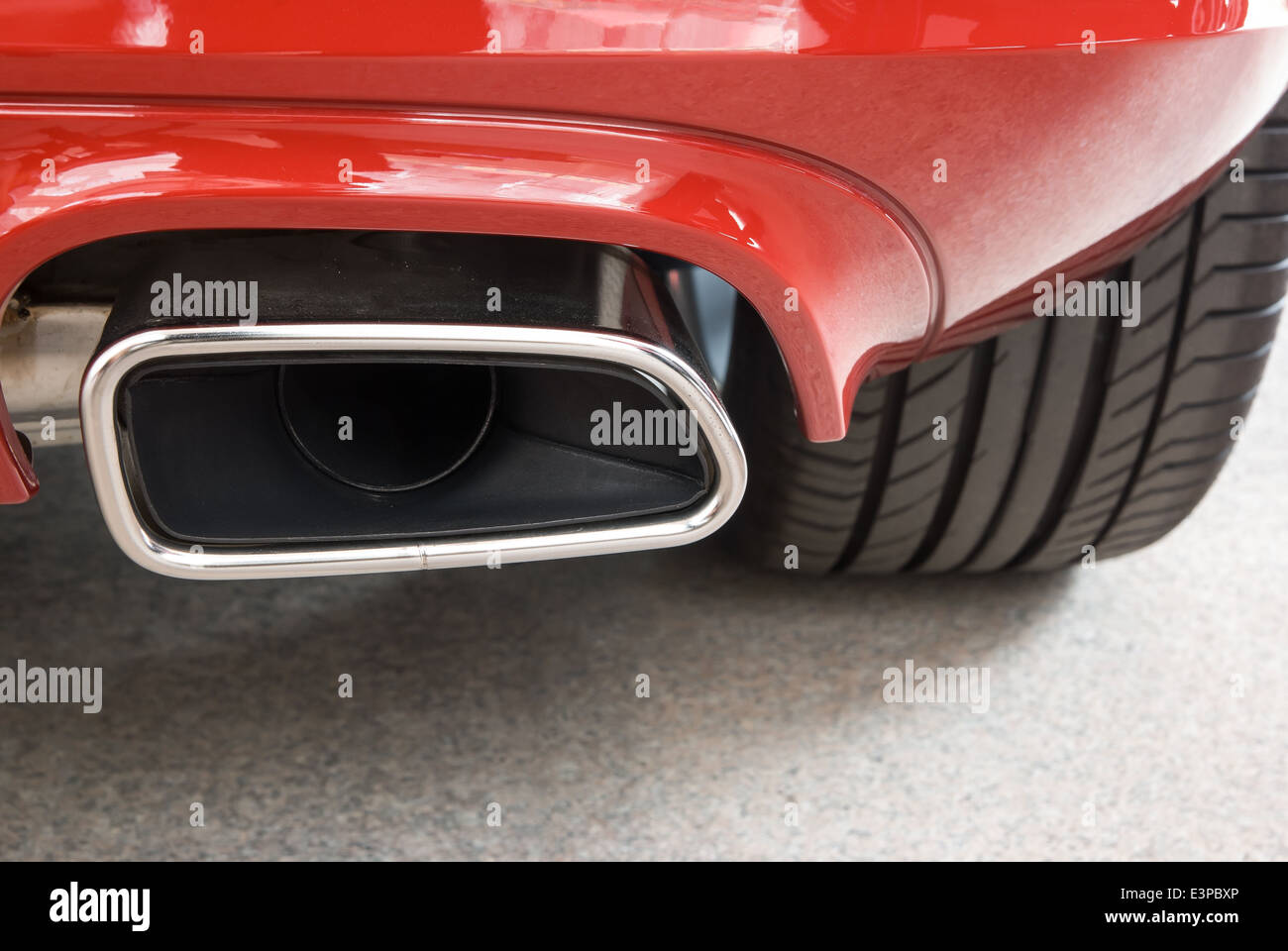 exhaust pipe of a red sports car Stock Photo - Alamy