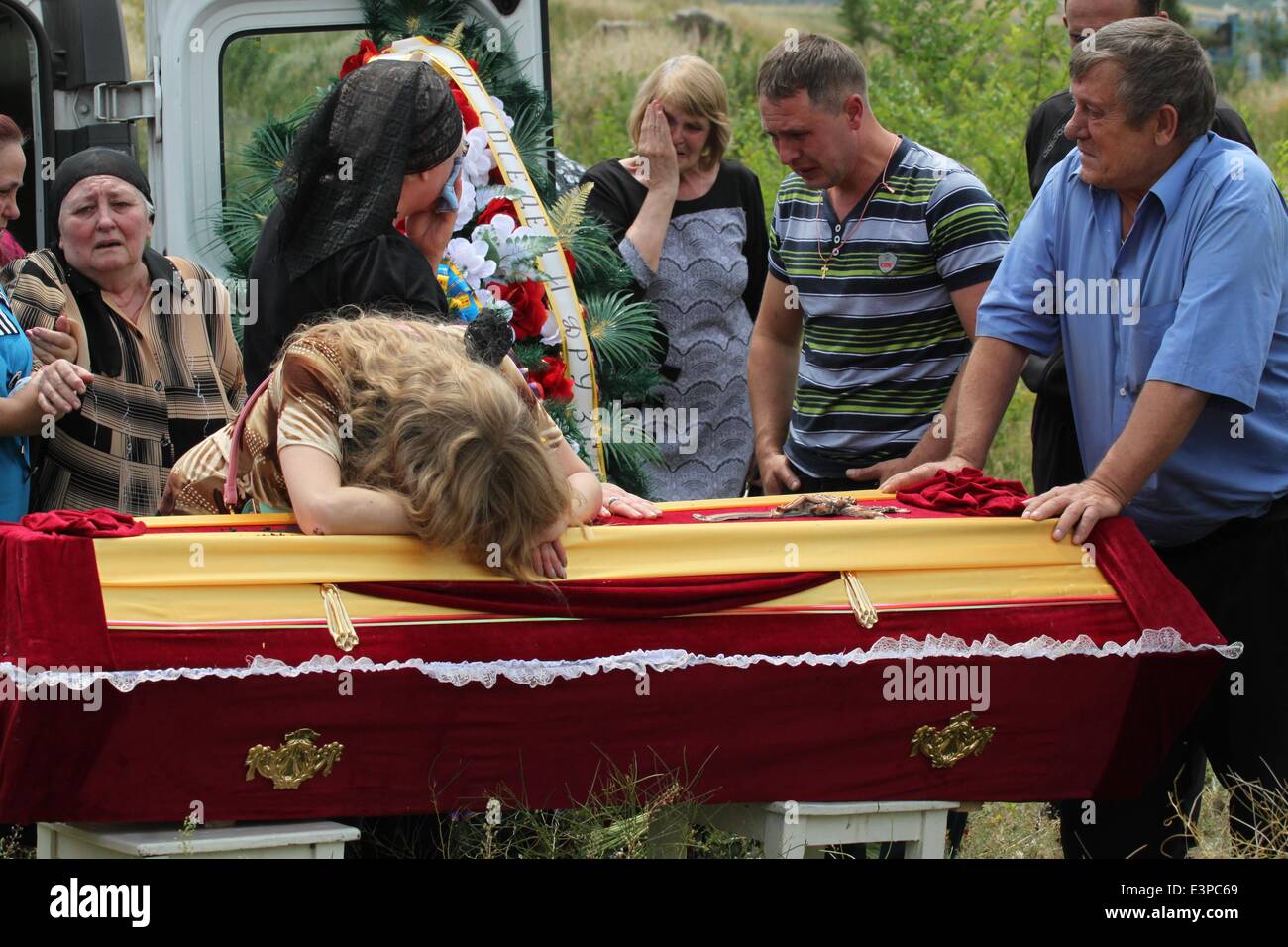 Krasnodon, Ukraine. 26th June, 2014. People cry during the funeral of ...