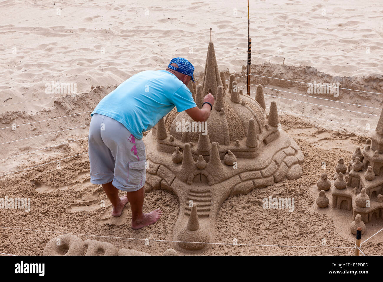Man building sandcastle on the beach hi-res stock photography and ...