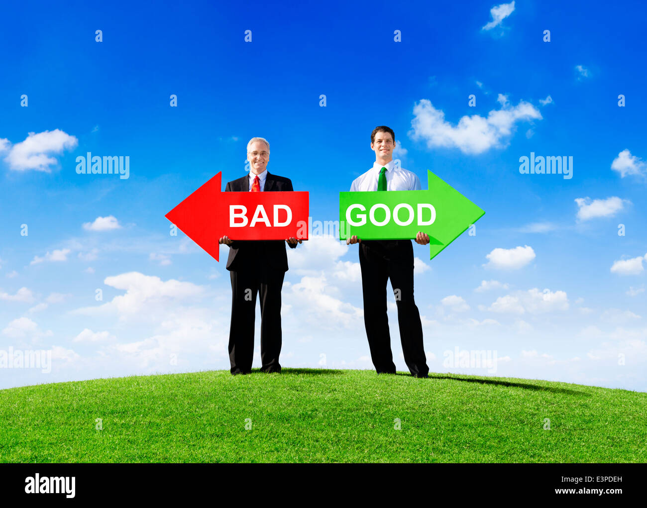 Two Businessmen Holding Contrasting Arrows for Bad and Good Stock Photo ...