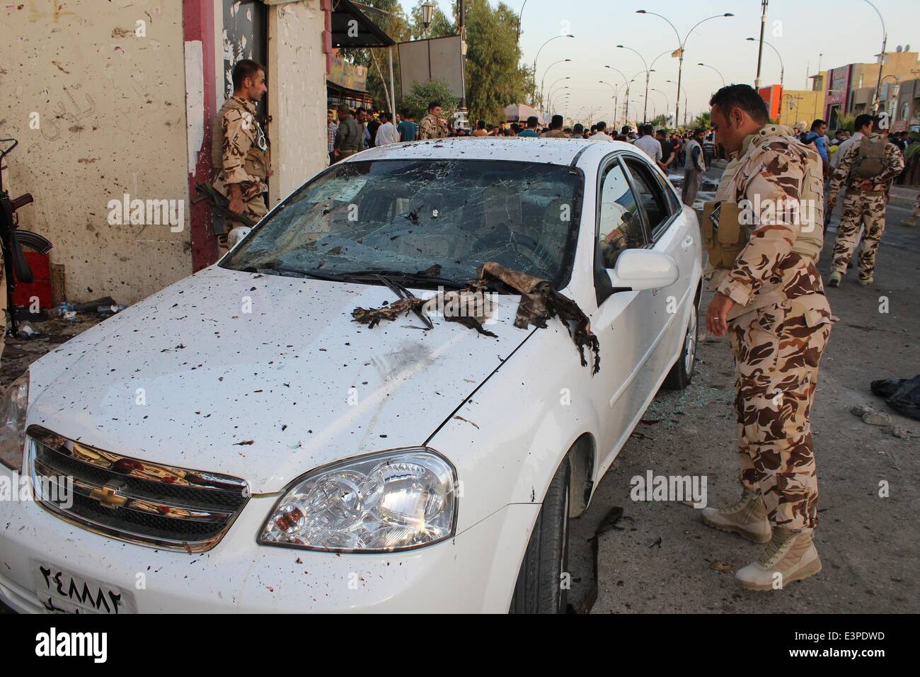 Kirkuk, Iraq. 25th June, 2014. Damaged car is seen at an explosion site ...