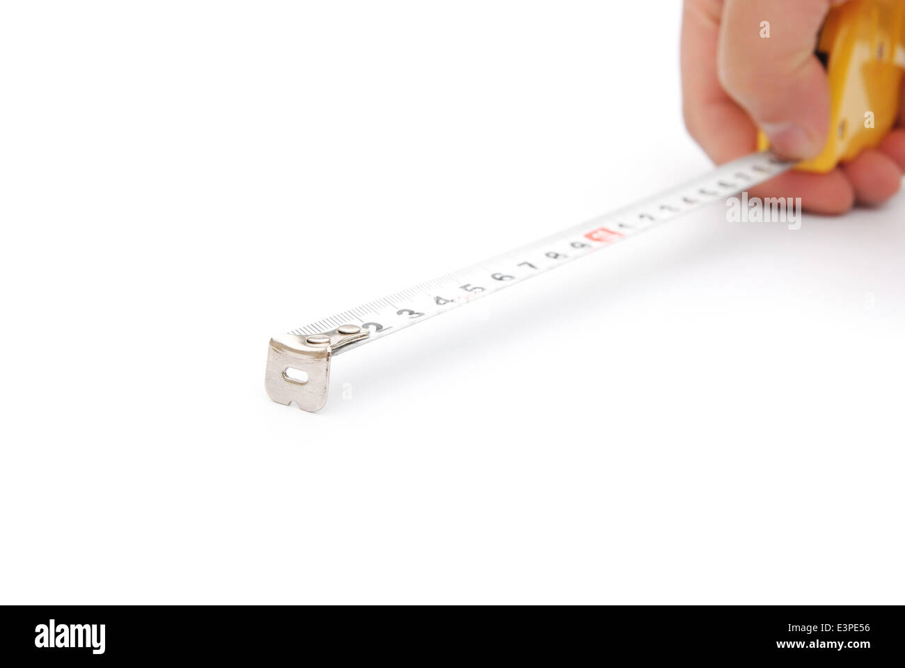 hand holding a tape measure on white Stock Photo - Alamy