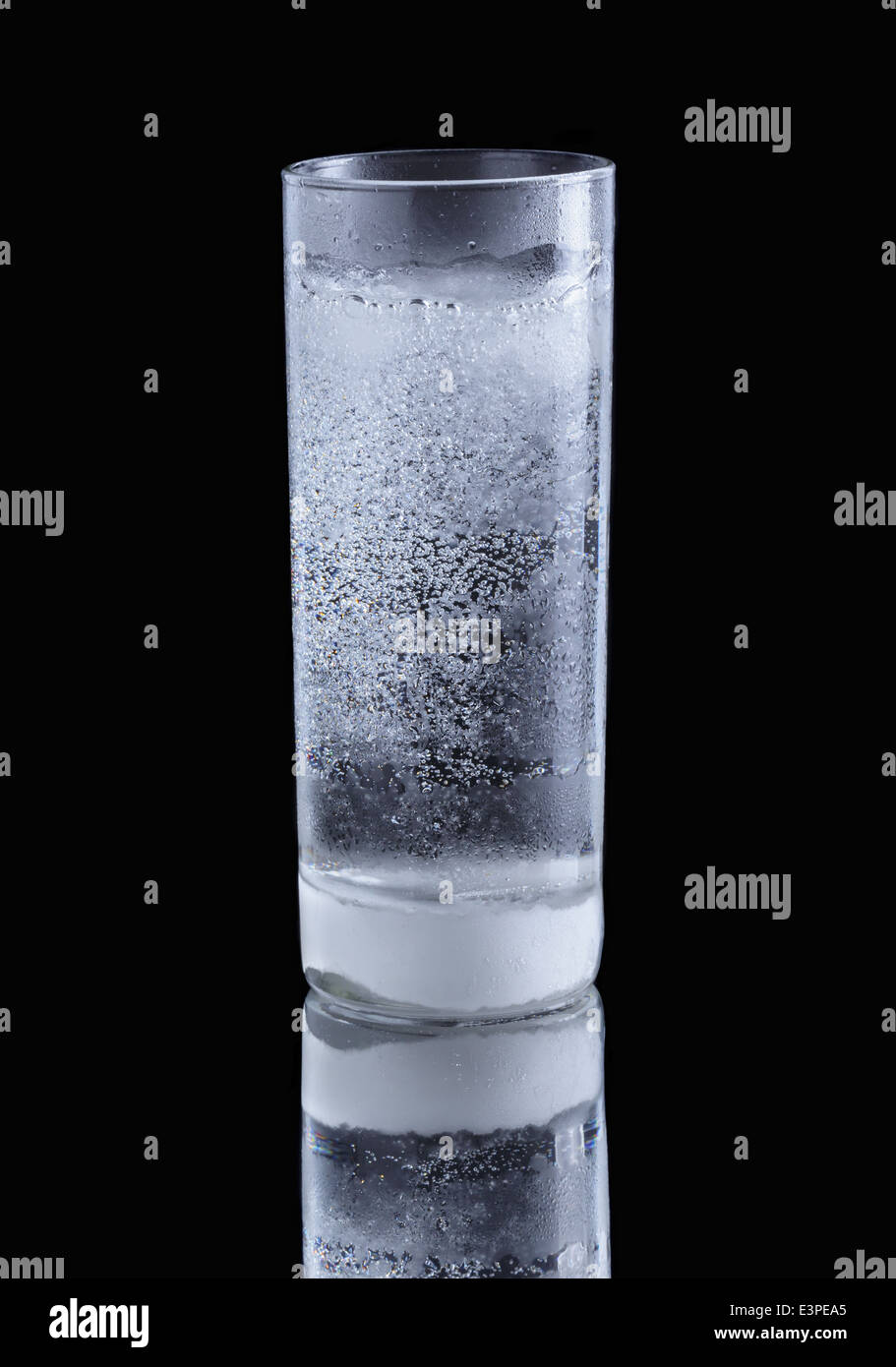 mineral water in simple highball glass, on black background Stock Photo - Alamy