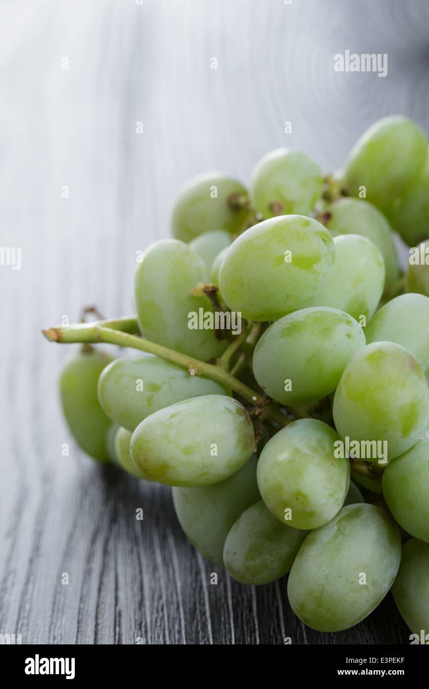 ripe green grapes on black wood table, close up Stock Photo - Alamy