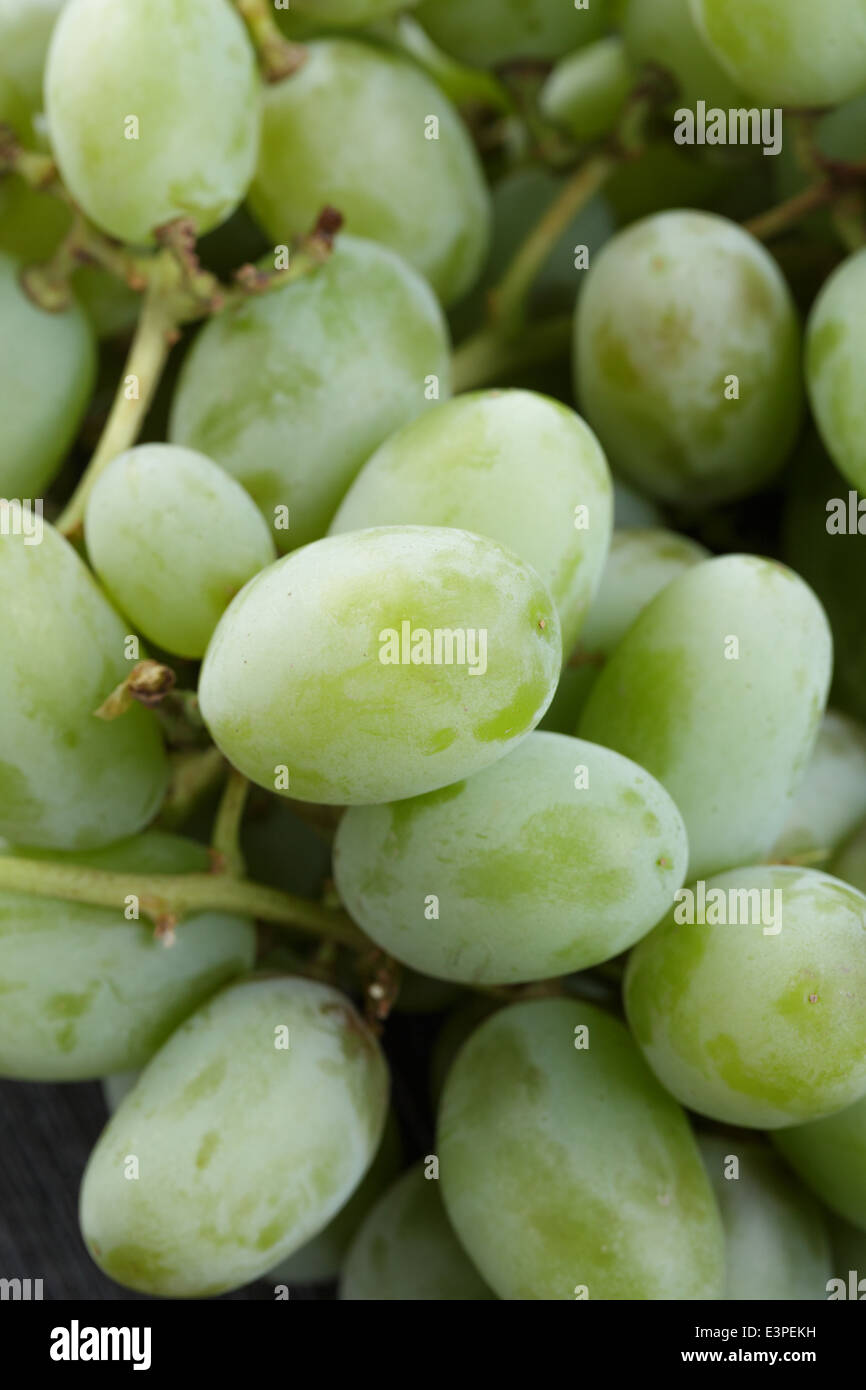 ripe green grapes on black wood table, close up Stock Photo - Alamy