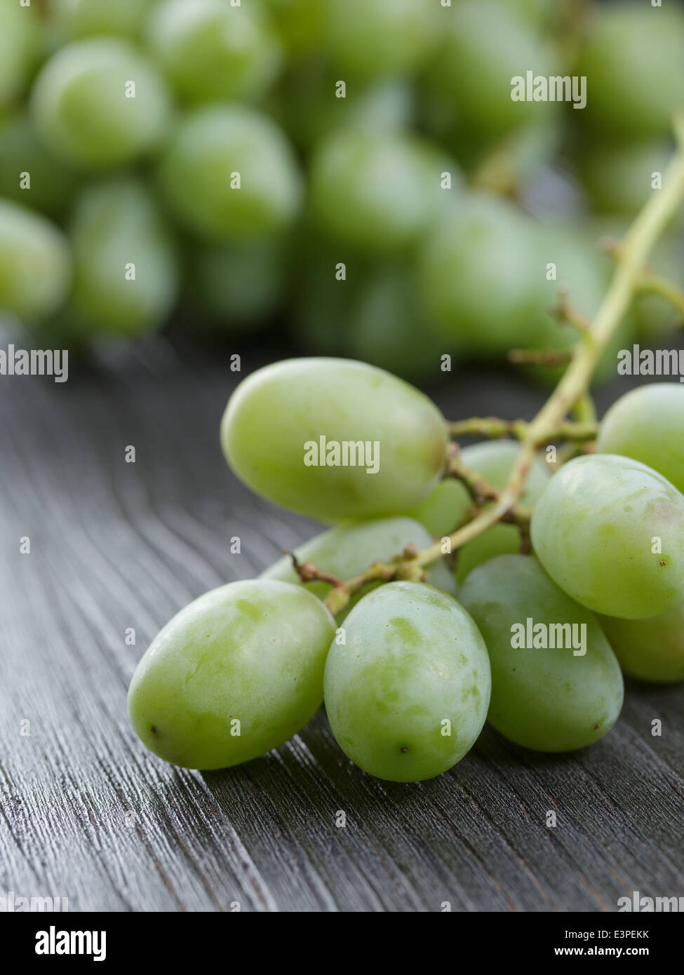 ripe green grapes on black wood table, close up Stock Photo - Alamy