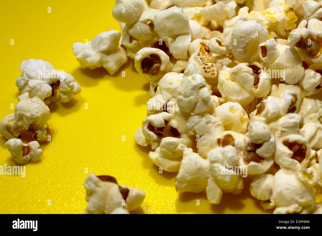 Popcorn on a yellow background Stock Photo - Alamy