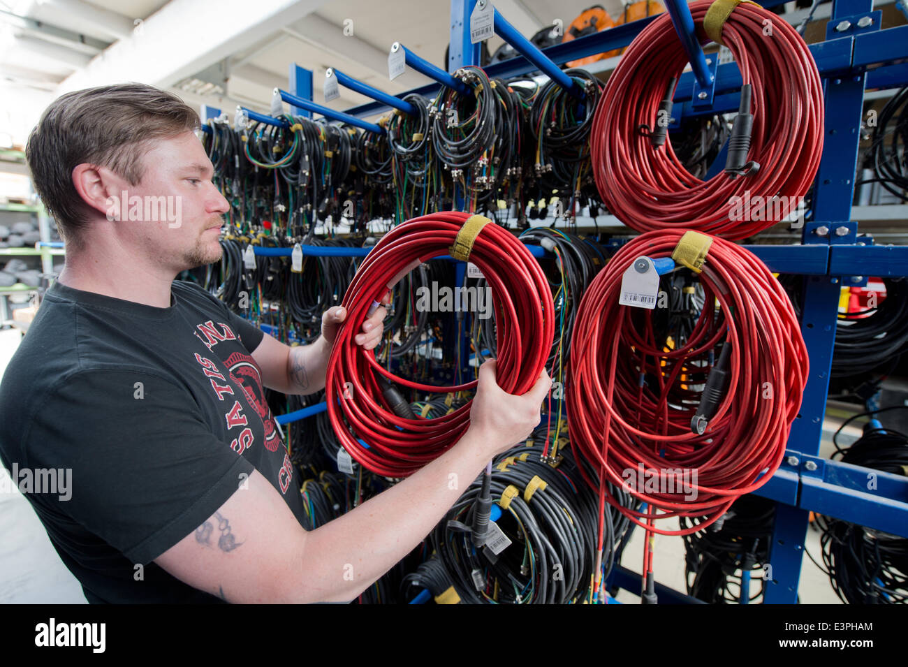 Karben, Germany. 23rd June, 2014. An employee of Satis & Fy sorts ...