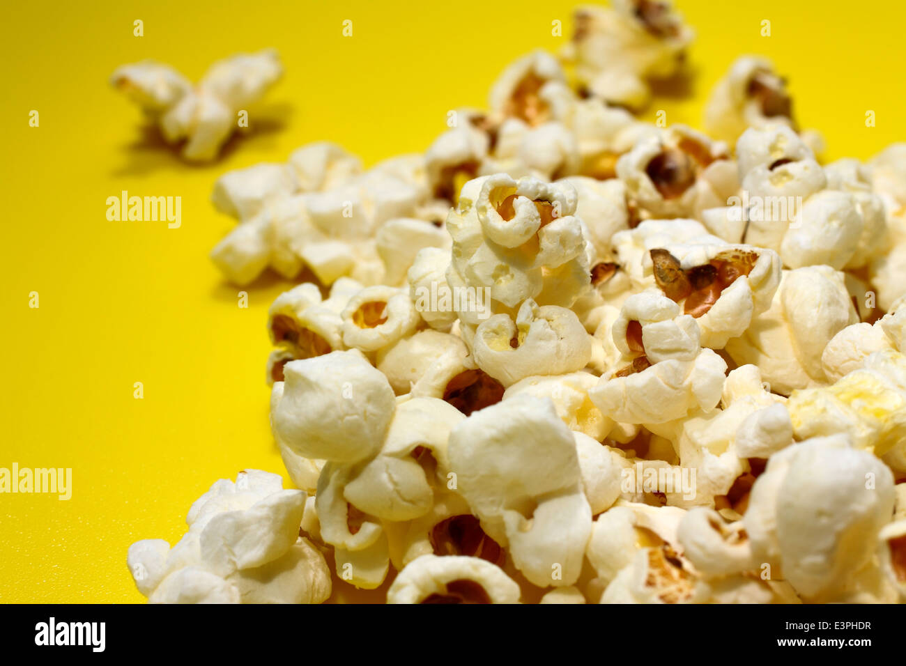 Popcorn on a yellow background Stock Photo - Alamy
