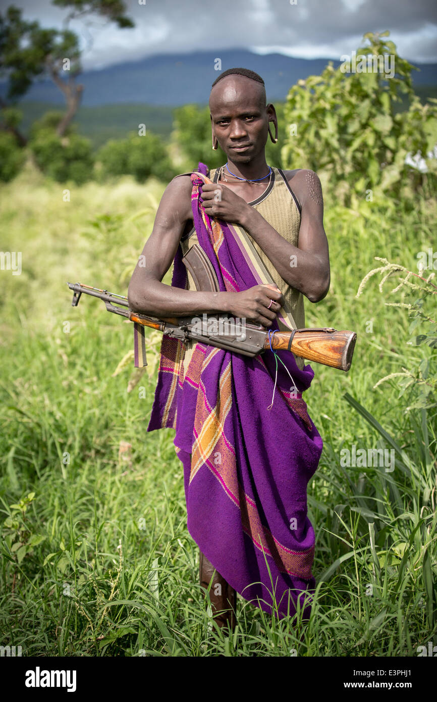 Suri warrior with kalashnikov in Kibish, Ethiopia 22 May 2014. Suri is ...