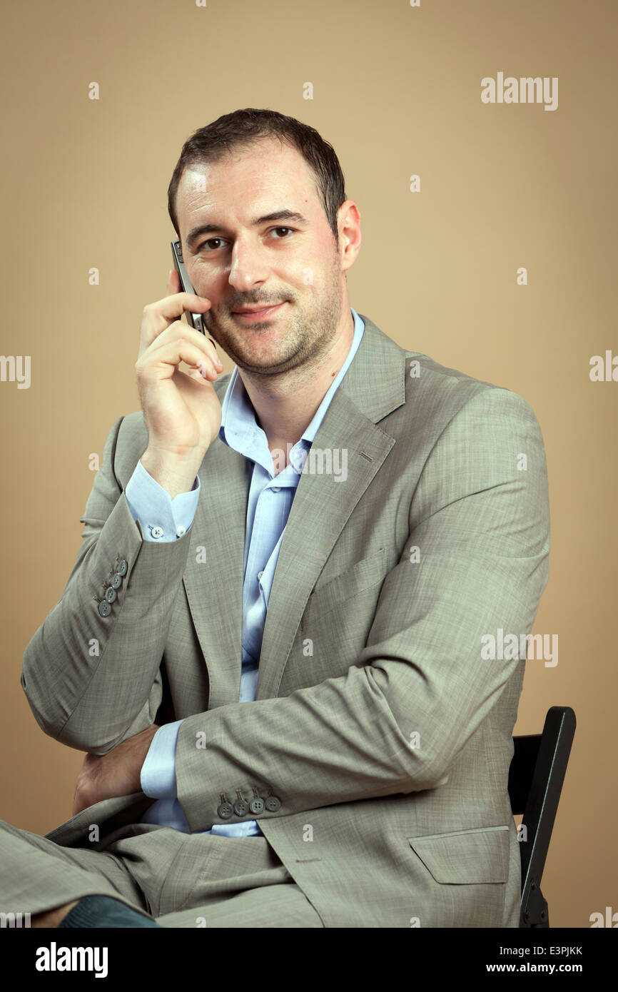 Relaxed man wearing classic business outfit while is making a phone ...