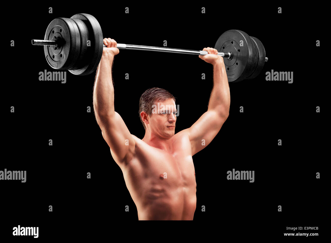 Bodybuilder lifting a heavy weight on black background Stock Photo - Alamy