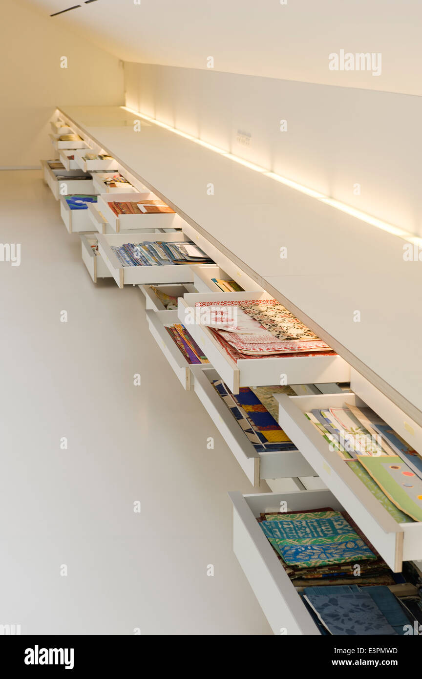 A row of open drawers containing painted paper fabric samples Stock ...