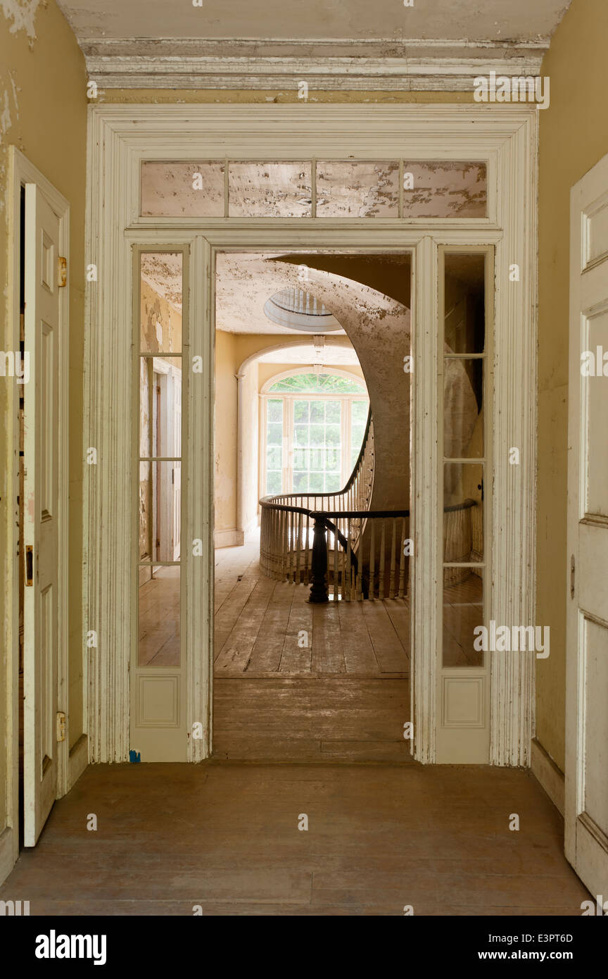 View through doorway with fanlight to elliptical staircase on first ...
