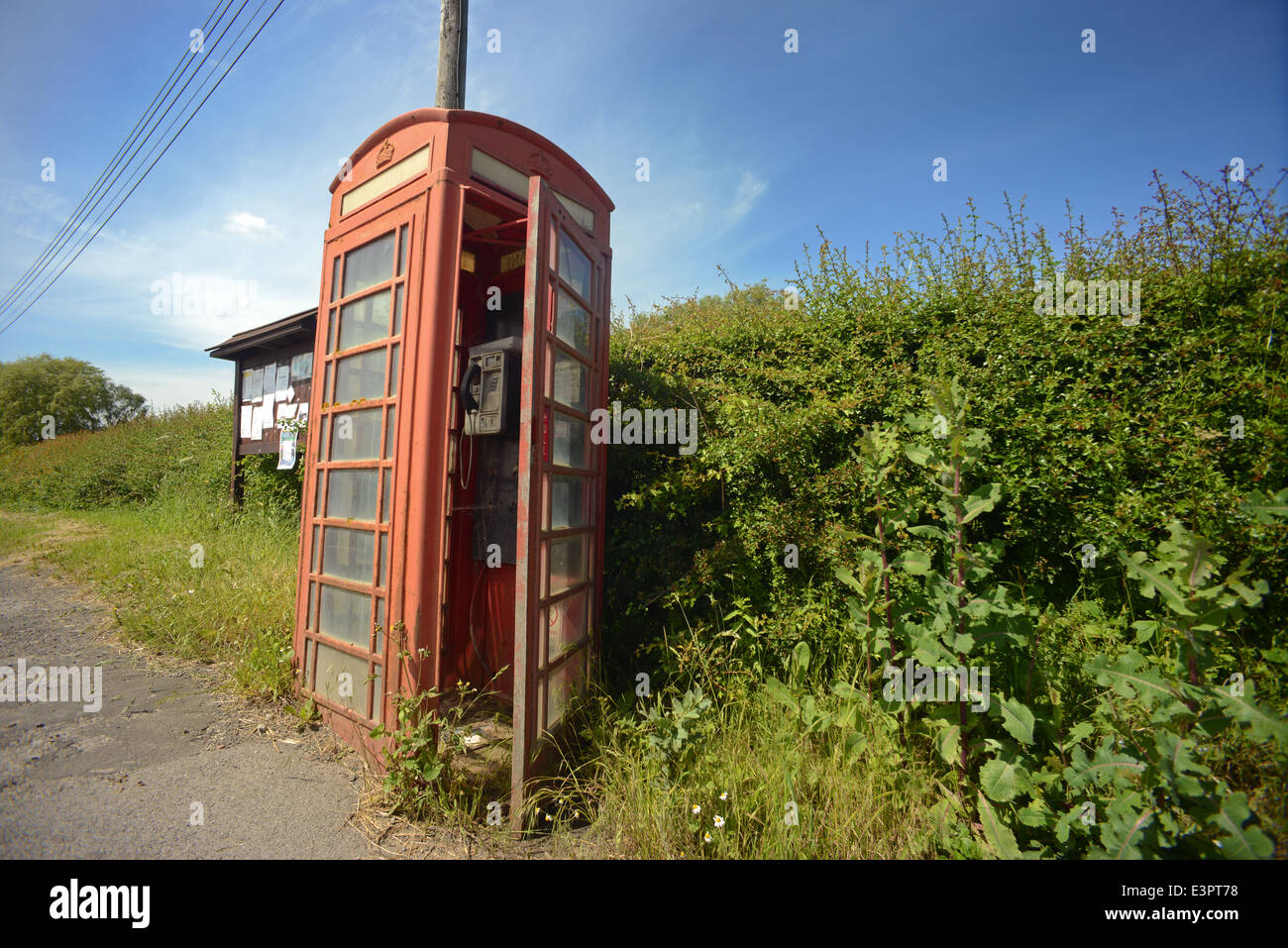 overgrown telephone box united kingdom Stock Photo - Alamy