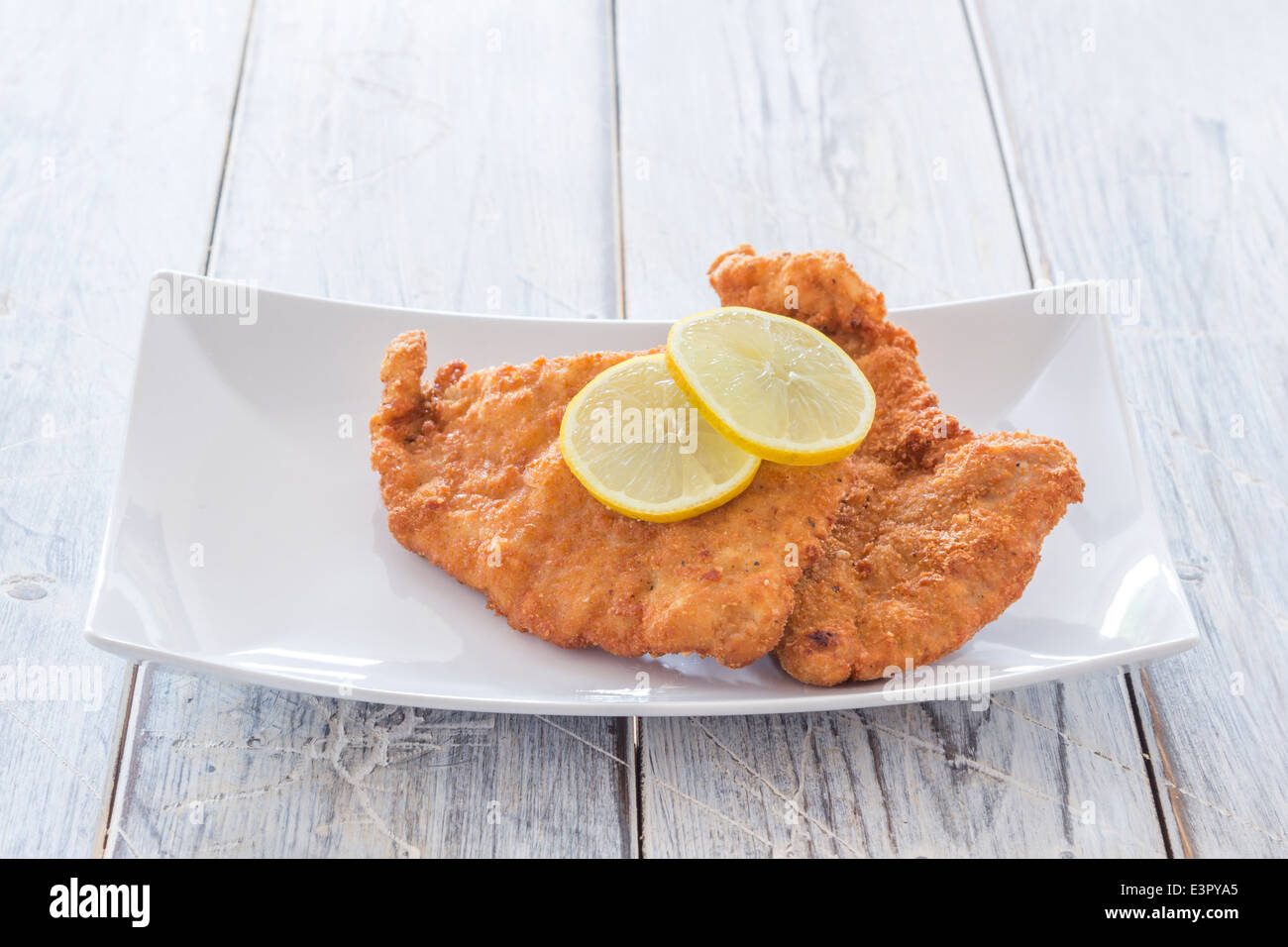 Viennese Schnitzel with lemon slices on a plate Stock Photo - Alamy