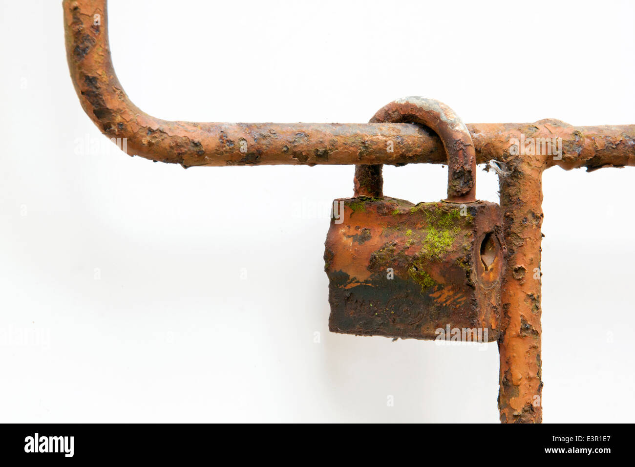 extremely rusted padlock on bar of rusty metal gate Stock Photo - Alamy