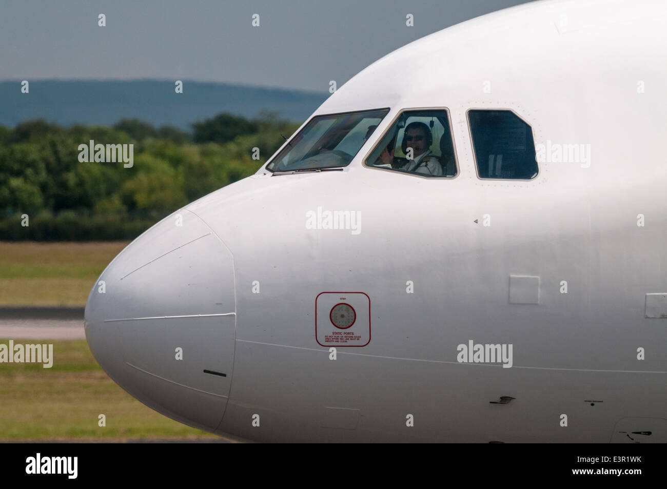 Pilot looking out of the cockpit windows of a Thomas Cook Airbus A321 ...