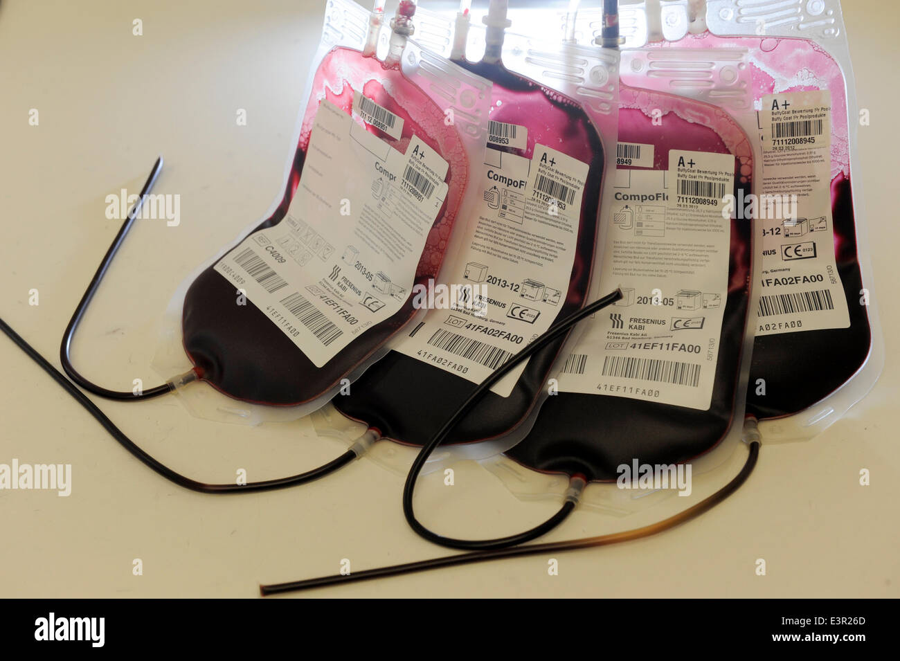Blood bottles are laying on a table in the blood donation centre of the ...