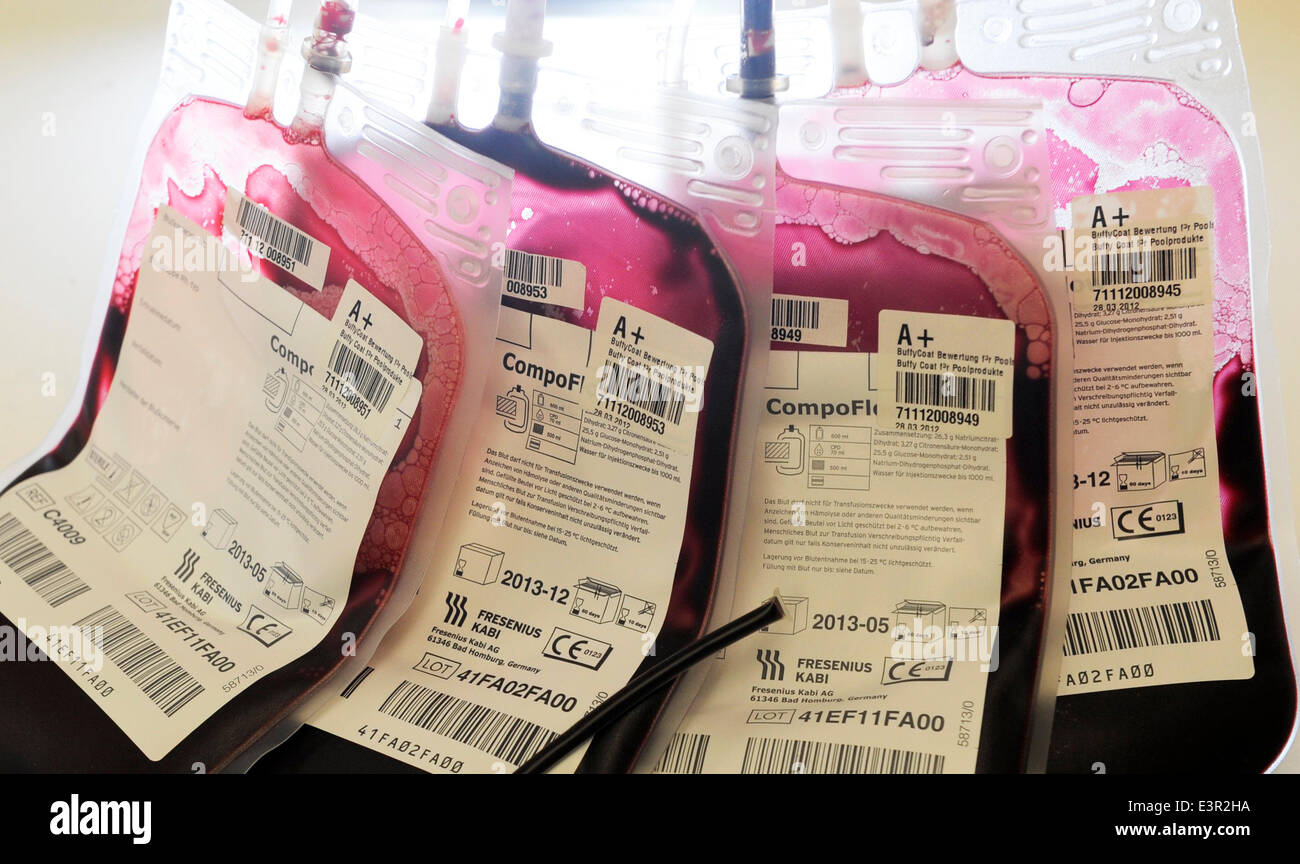 Blood bottles are laying on a table in the blood donation centre of the ...