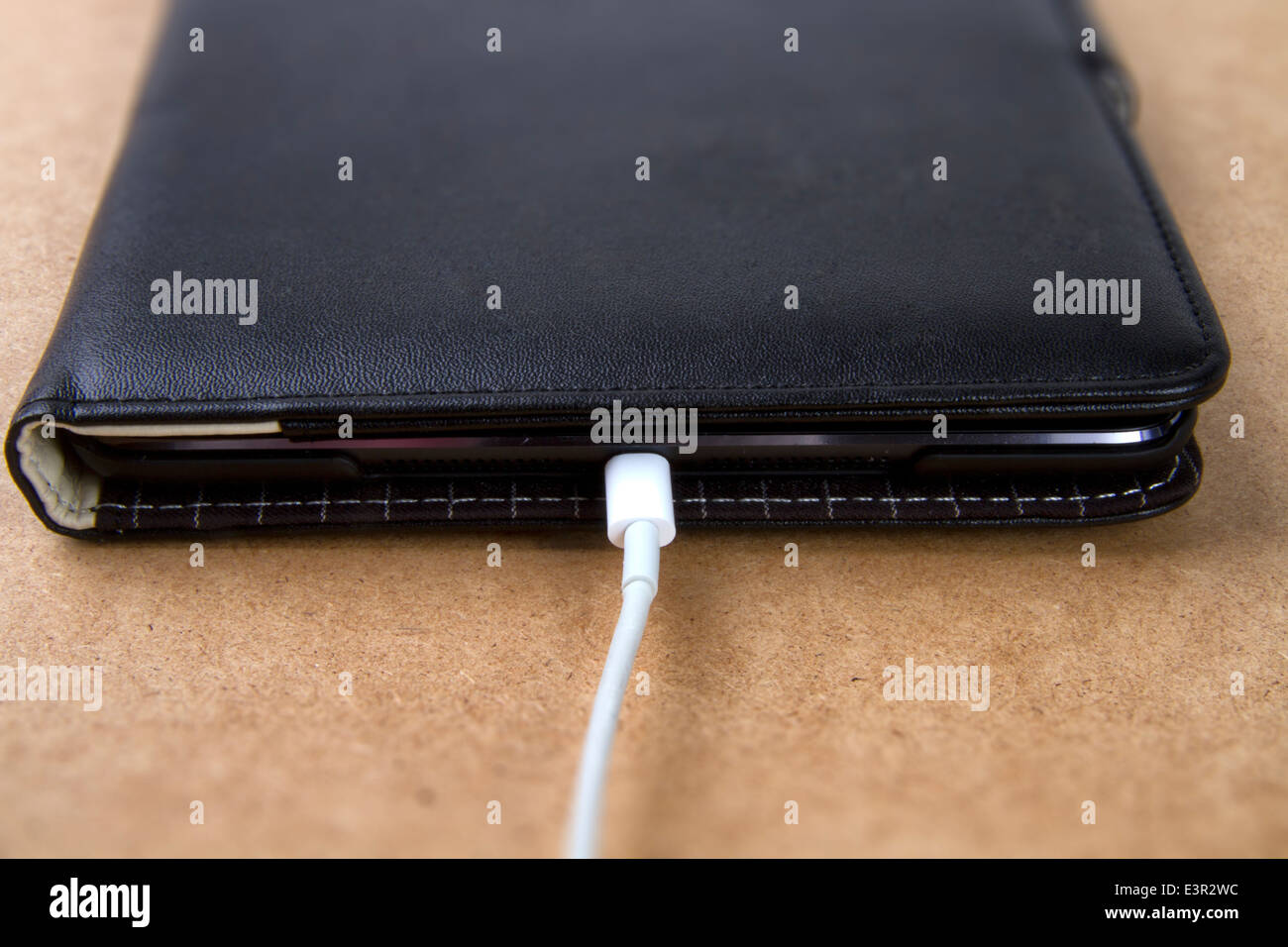 Charging cable connected to an iPad mini Stock Photo - Alamy