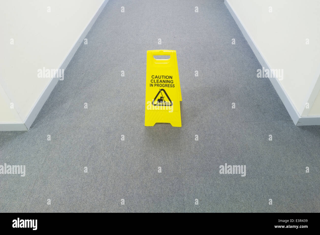 Temporary sign in corridor reading "Caution, cleaning in progress Stock ...