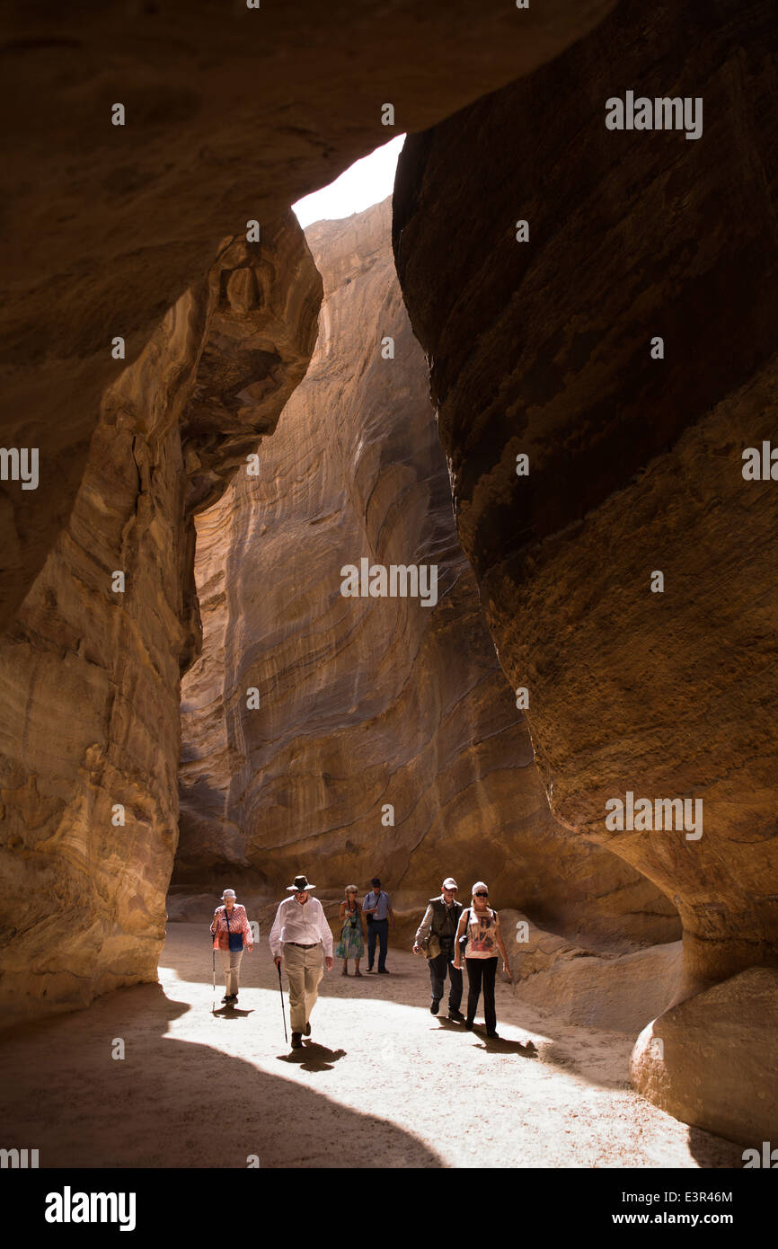 Jordan, Arabah, Petra, tourist s walking through Al-Siq entrance canyon ...