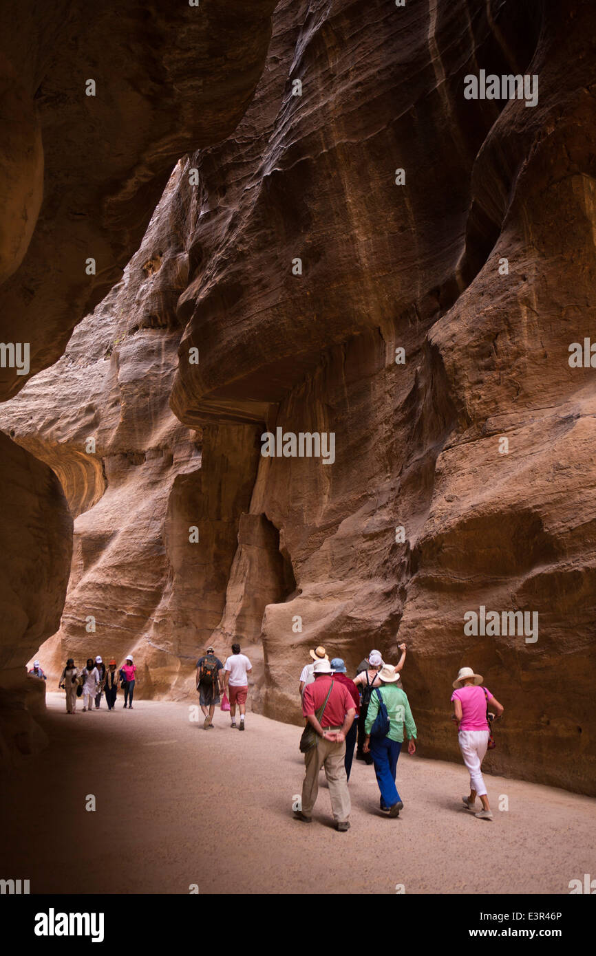 Jordan, Arabah, Petra, tourists walking through Al-Siq entrance canyon ...