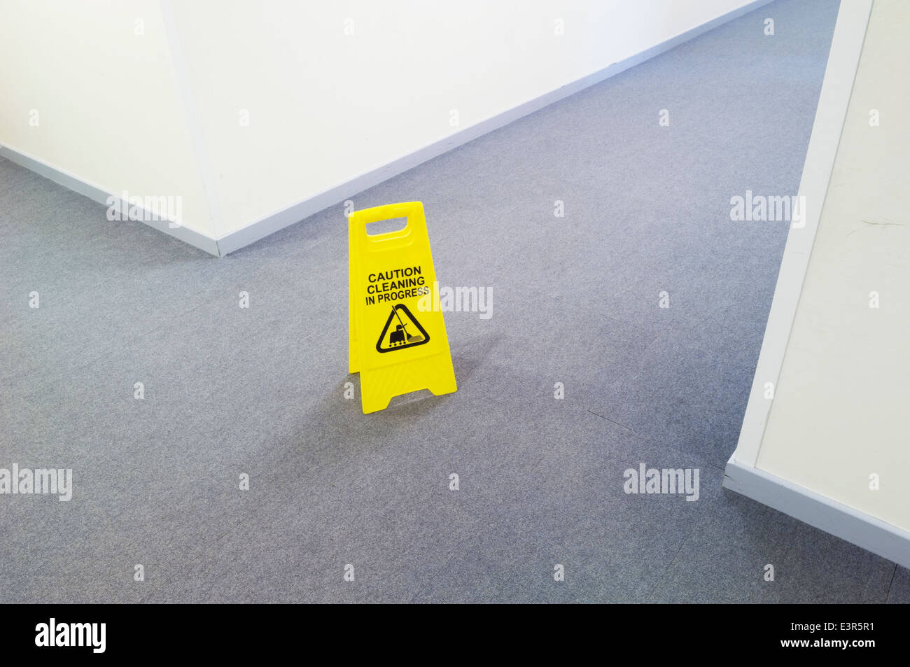 Temporary sign in corridor reading "Caution, cleaning in progress Stock ...