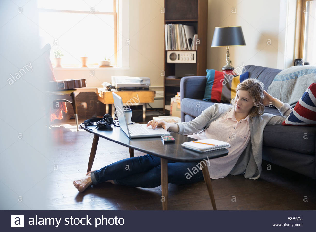 Woman watching laptop floor hi-res stock photography and images - Alamy