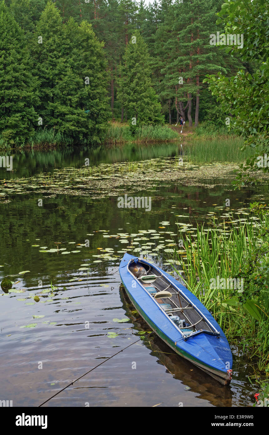 Forest river and canoe Stock Photo - Alamy