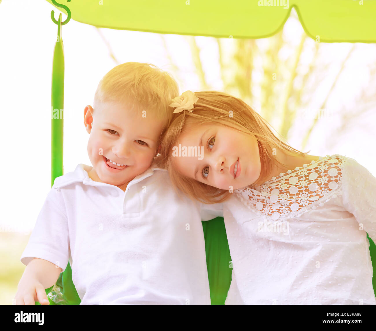Happy little child playing outdoors in sunny day, brother with sister ...