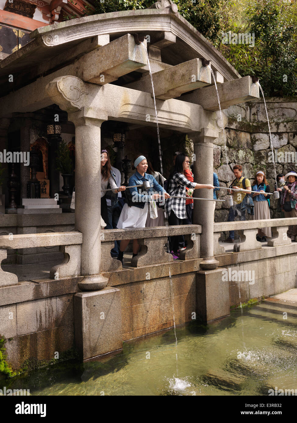 Young Japanese women at Otowa-no-taki sacred waterfall drinking for ...
