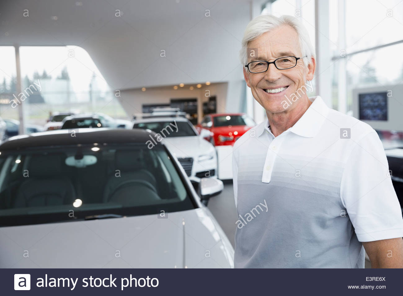 Portrait of smiling man in car dealership showroom Stock Photo - Alamy