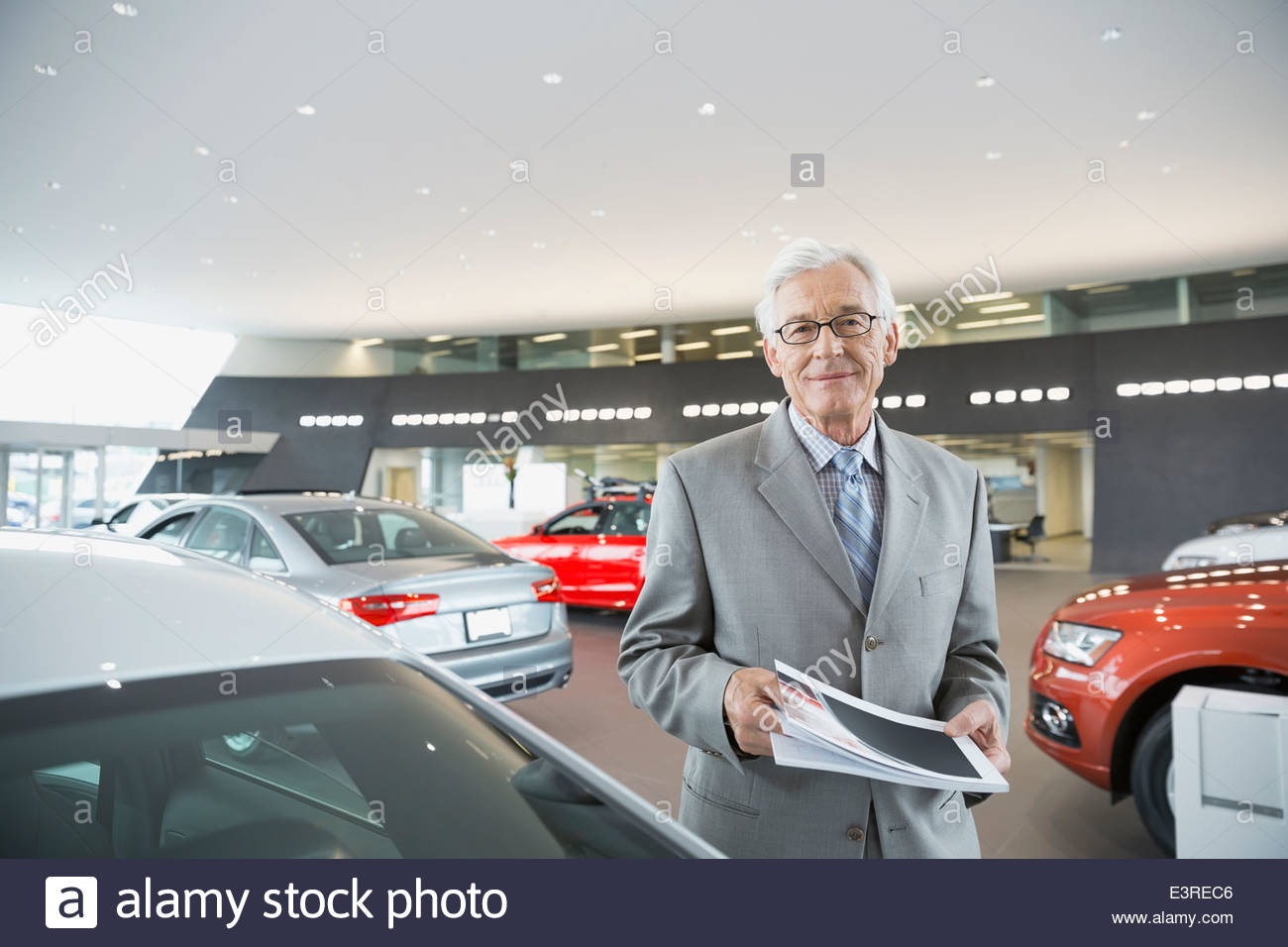 Salesman posing car showroom hi-res stock photography and images - Alamy